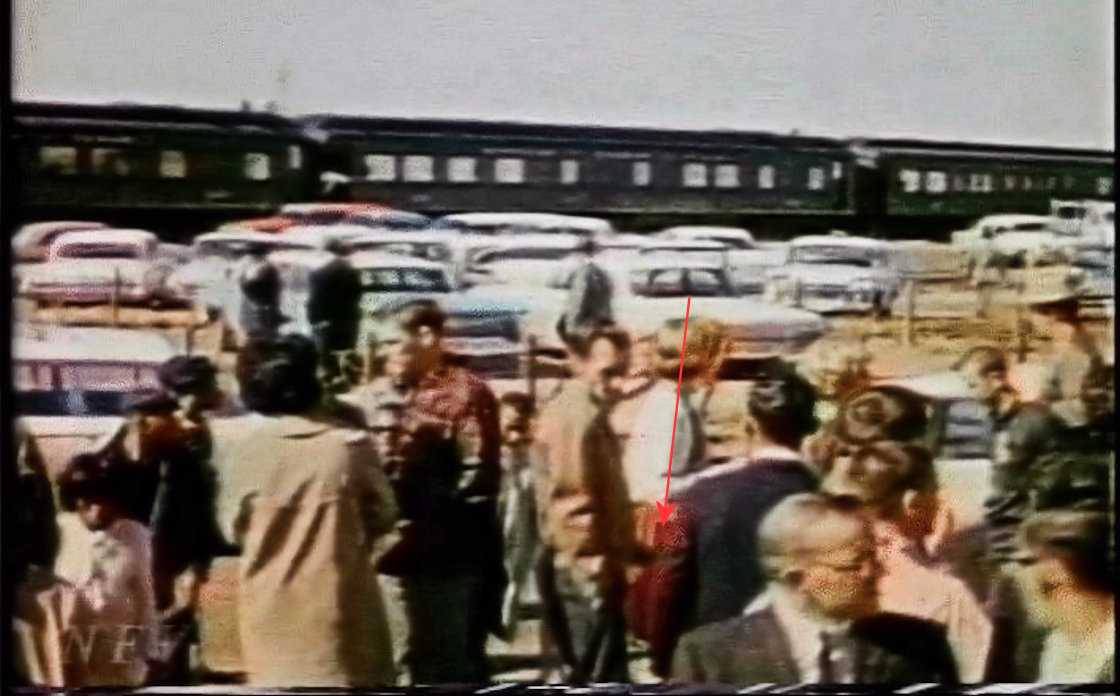 "Tan Jacket Man" Secretively Hands Something to "Blue Coated Guy" in ...