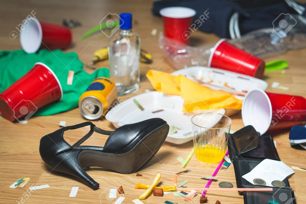 77001108 terrible mess after party trash bottles food cups and clothes ...