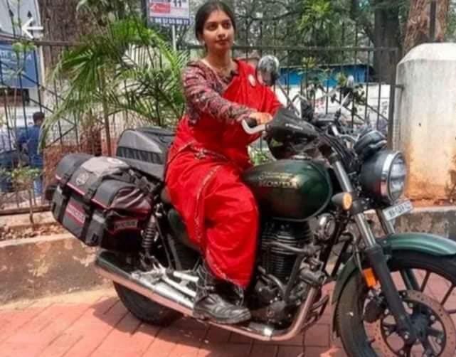 Woman wearing a saree on a bike. Ready for a world trip