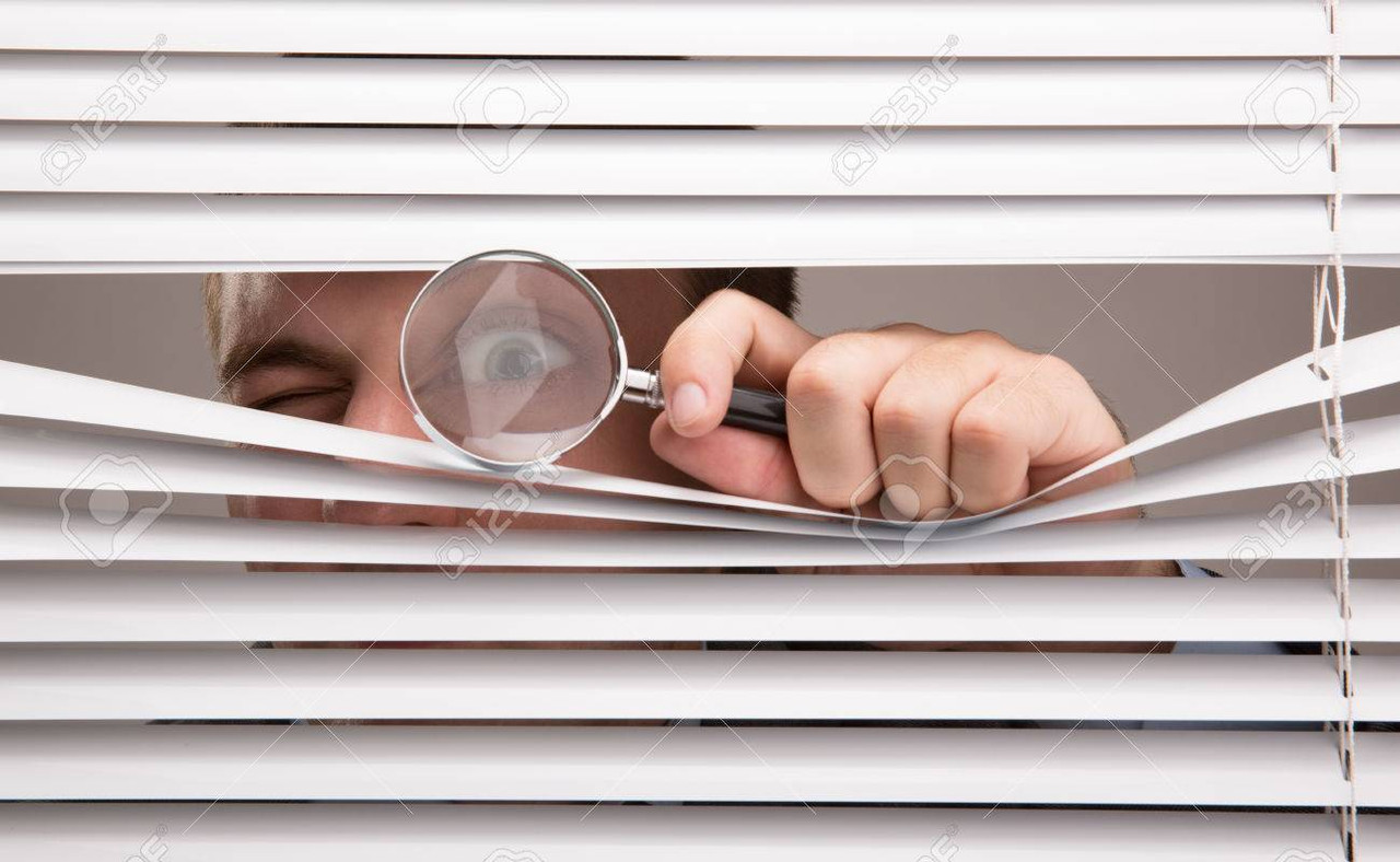 23894264 a young man looking through window blinds — Postimages